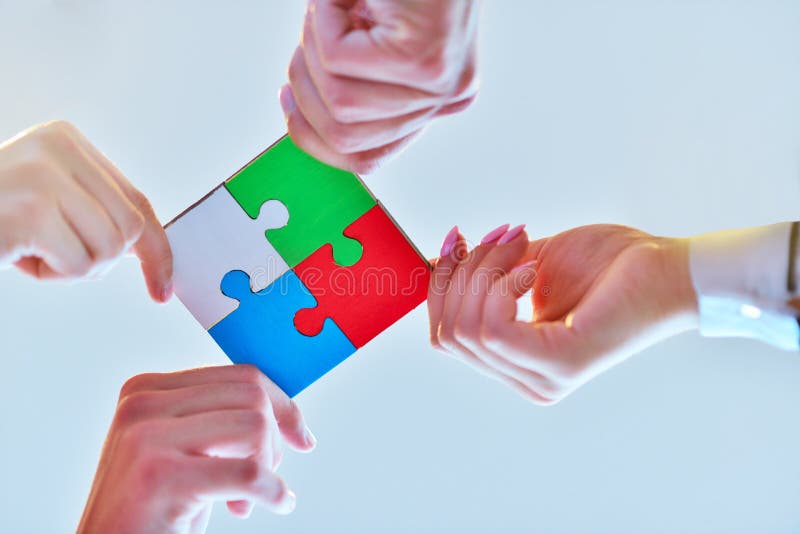 Business People Group Assembling Jigsaw Puzzle and Represent Team ...