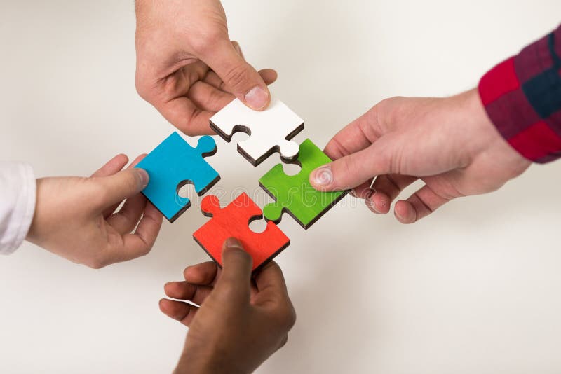 Business People Group Assembling Jigsaw Puzzle and Represent Team ...