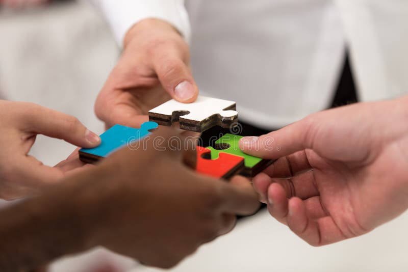 Business People Group Assembling Jigsaw Puzzle and Represent Team ...