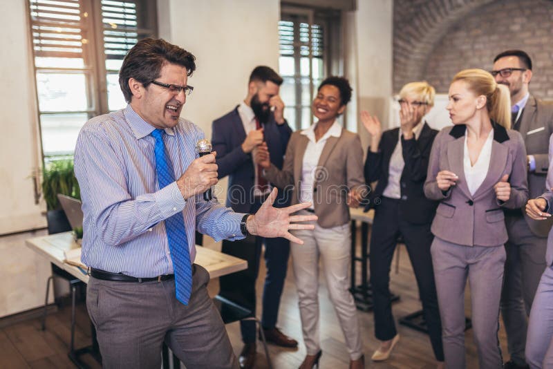Business People Having Karaoke Party at Co-working Space, Singing ...