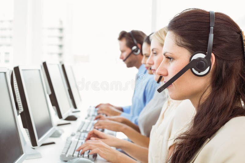 Business People with Headsets Using Computers in Office Stock Image ...