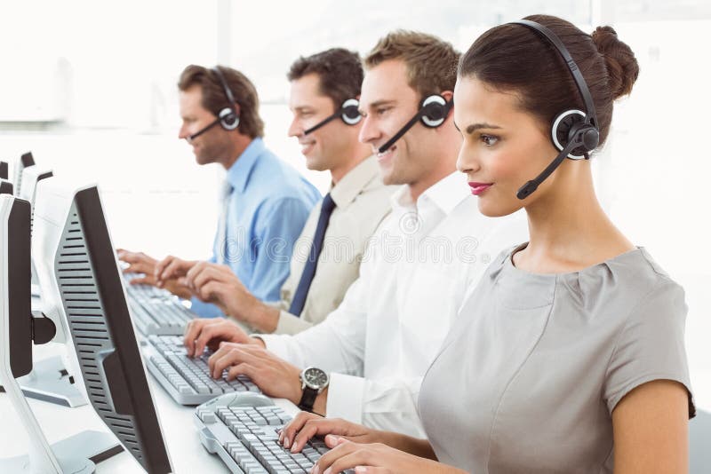 Business People with Headsets Using Computers in Office Stock Image ...