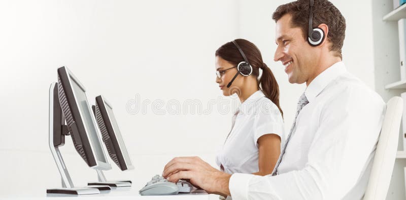 Business People with Headsets Using Computers in Office Stock Image ...