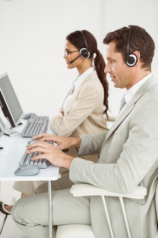 Business People with Headsets Using Computers in Office Stock Photo ...