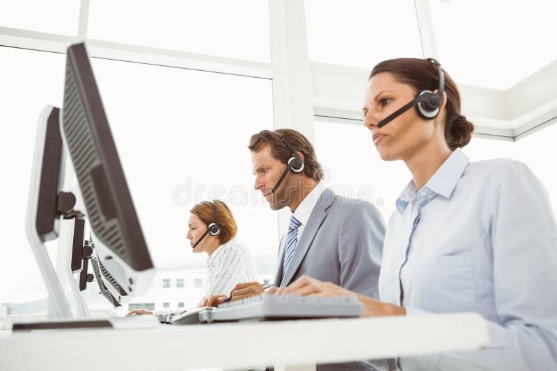 Business People with Headsets Using Computers in Office Stock Photo ...