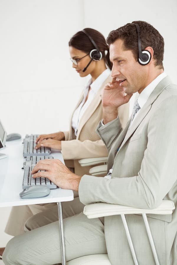 Business People with Headsets Using Computers Stock Image - Image of ...