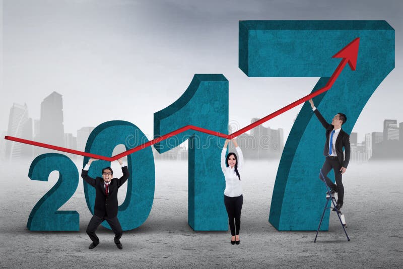 Business People Holding Graph with Numbers 2017 Stock Photo - Image of ...