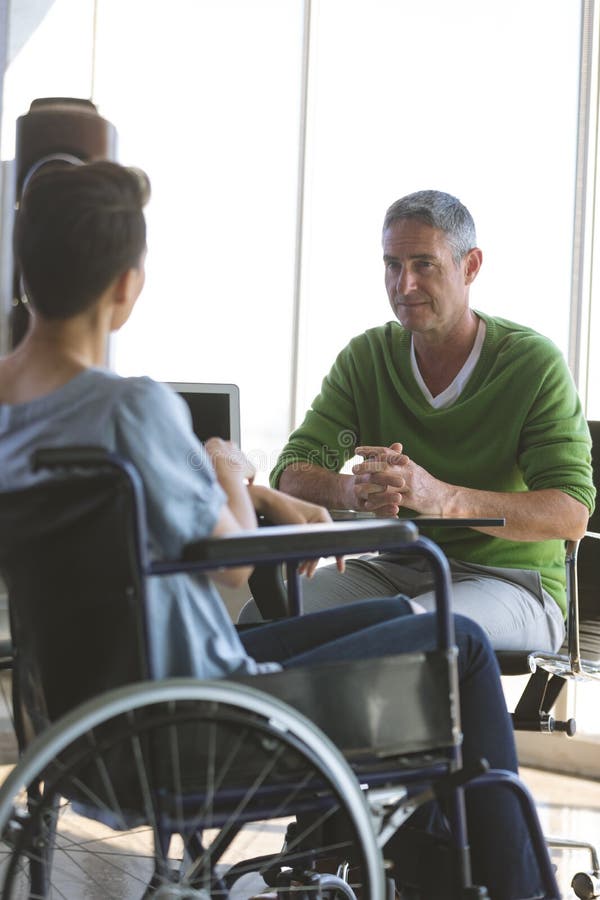 Business People Interacting with Each Other at Desk Stock Image - Image ...