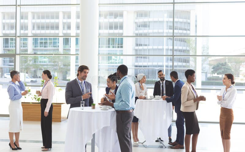 Business People Interacting with Each Other at Table during a Seminar ...