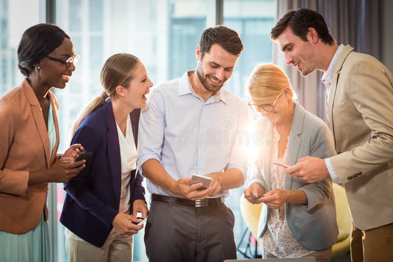 Business People Interacting Using Mobile Phone Stock Photo - Image of ...