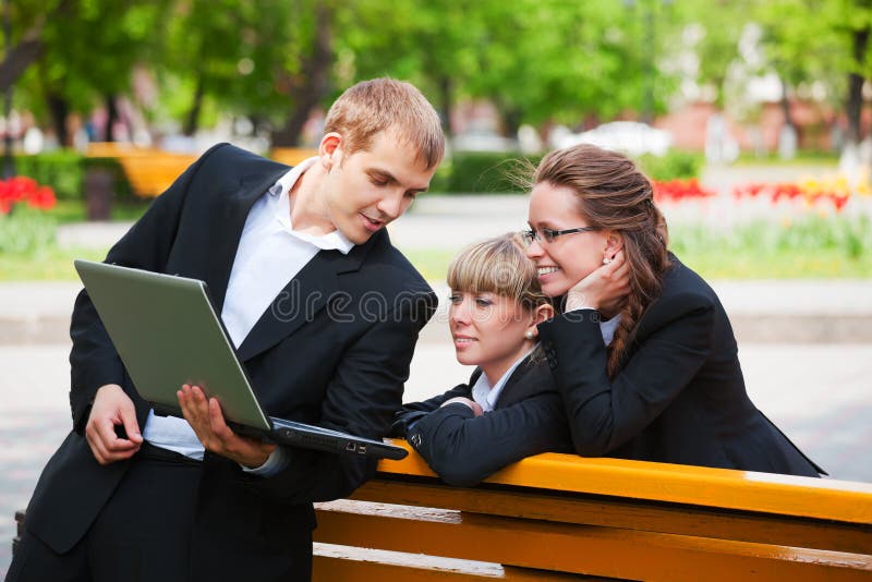 Young Business People Using Laptop in City Park Stock Image - Image of ...