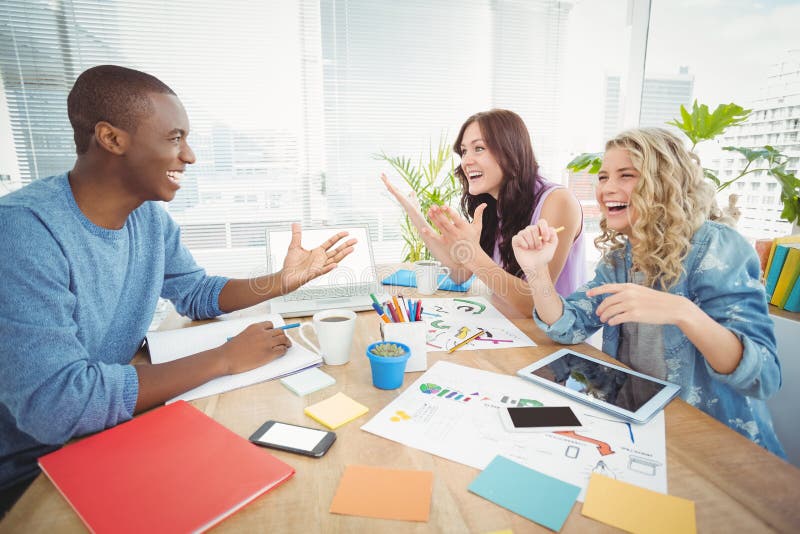 Business People Laughing while Working at Desk Stock Photo - Image of ...