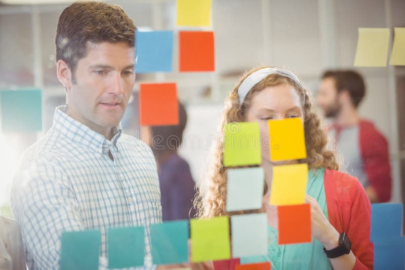 Business People Looking at Post it on the Wall Stock Photo - Image of ...