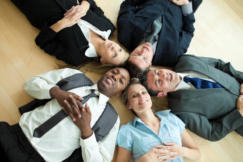 Business People Lying in a Circle on the Floor Stock Photo - Image of ...