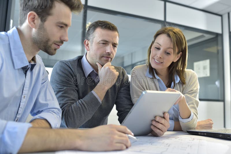 Business People Meeting and Discussing a New Project on a Tablet Stock ...