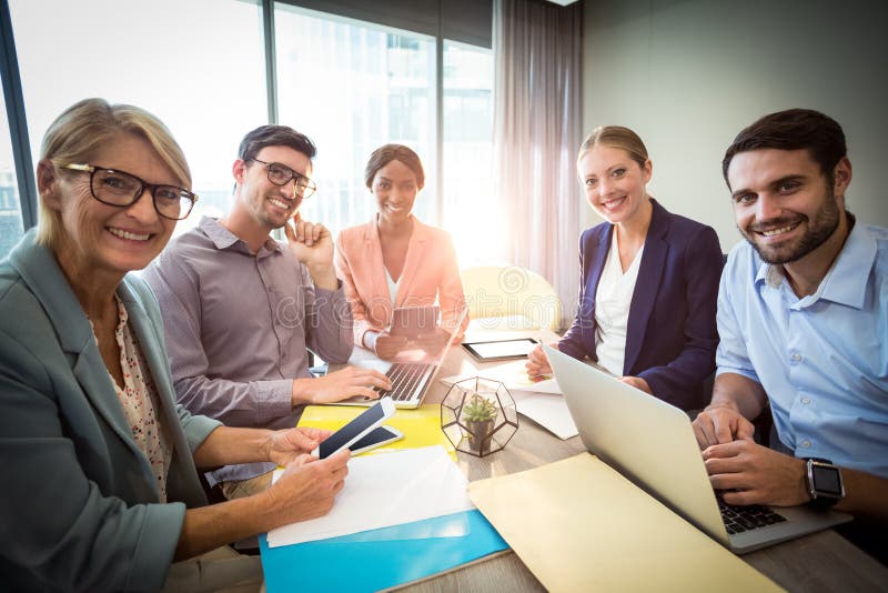 Business People Standing Over Laptop at Table in Office Stock Photo ...