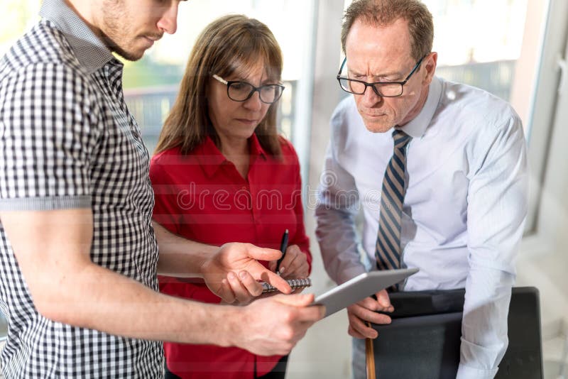 Business People in Meeting Working on Tablet, Overlayed with Ray Stock ...