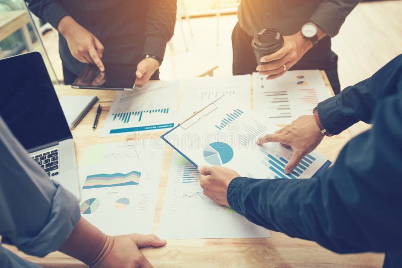 Business People Pointing Graph Sheets on Table during Discussion Stock ...