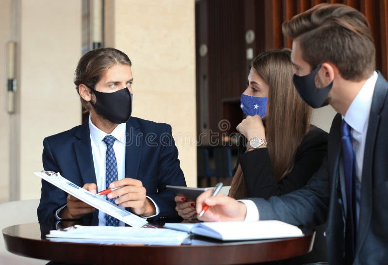 Business People in Protective Masks Working on New Project at Modern ...