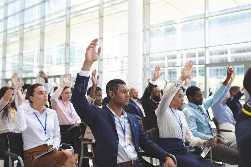 Business People Raising Hands in a Business Seminar Stock Image - Image ...