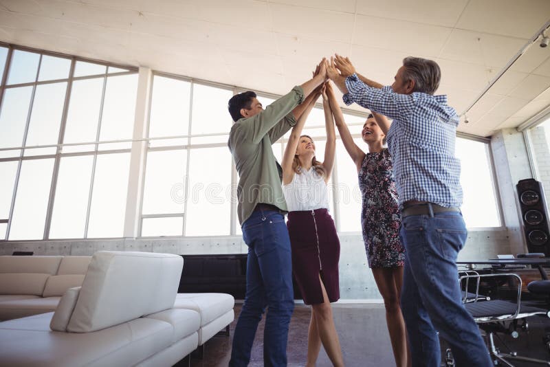 Business People Raising Hands Together at Office Stock Image - Image of ...