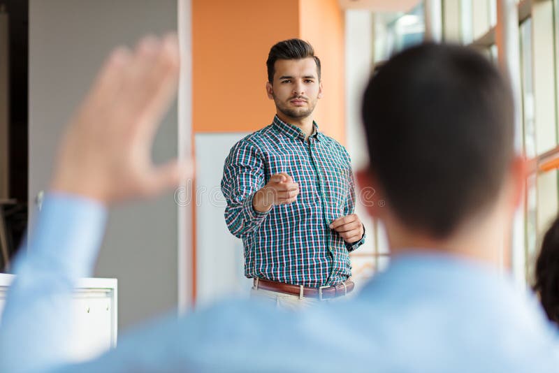 Business People Raising There Hand Up at a Conference To Answer a ...
