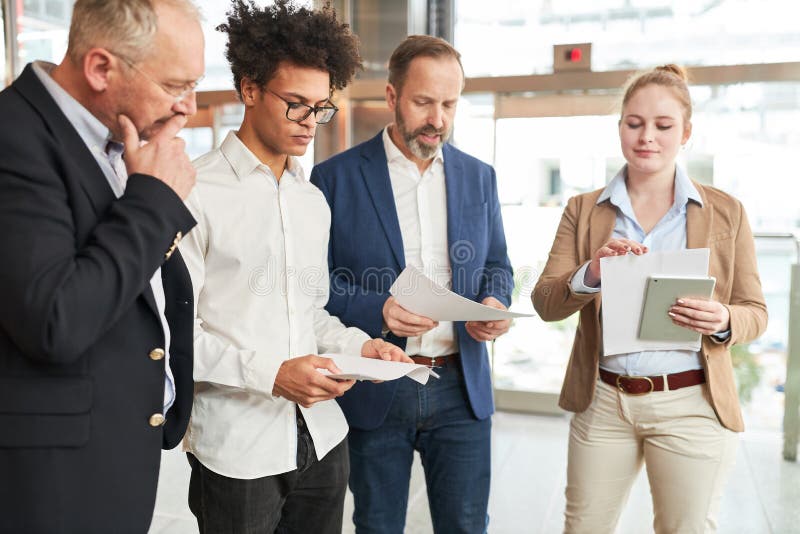 Business People Read Business Papers while Brainstorming Stock Photo ...