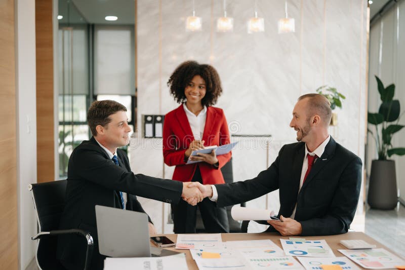 Business People Shaking Hands during a Meeting in Modern Office Stock ...