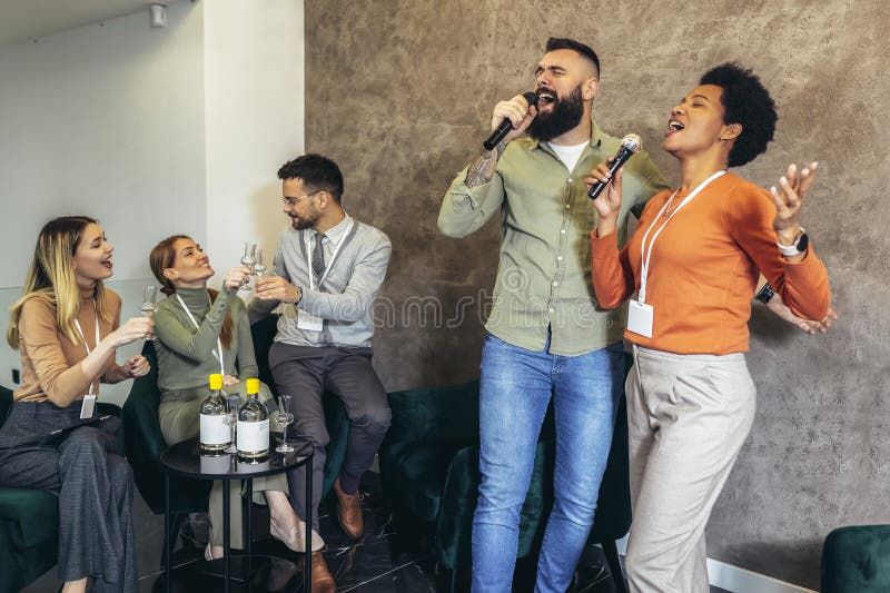 Business People Singing Karaoke in Modern Office Stock Image - Image of ...