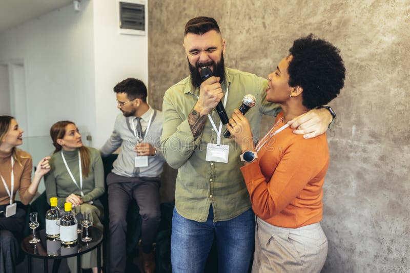 Business People Singing Karaoke in Modern Office Stock Photo - Image of ...