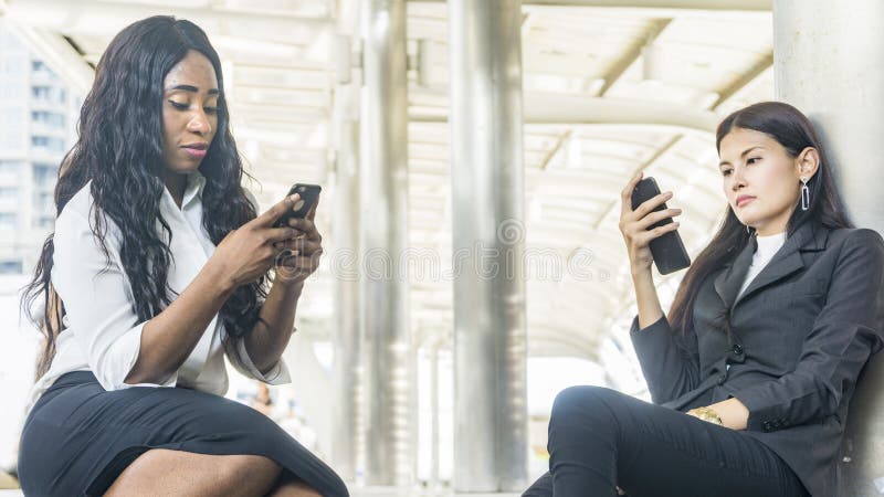 Business People Sit and Use Smart Phone at Outdoor Stock Image - Image ...