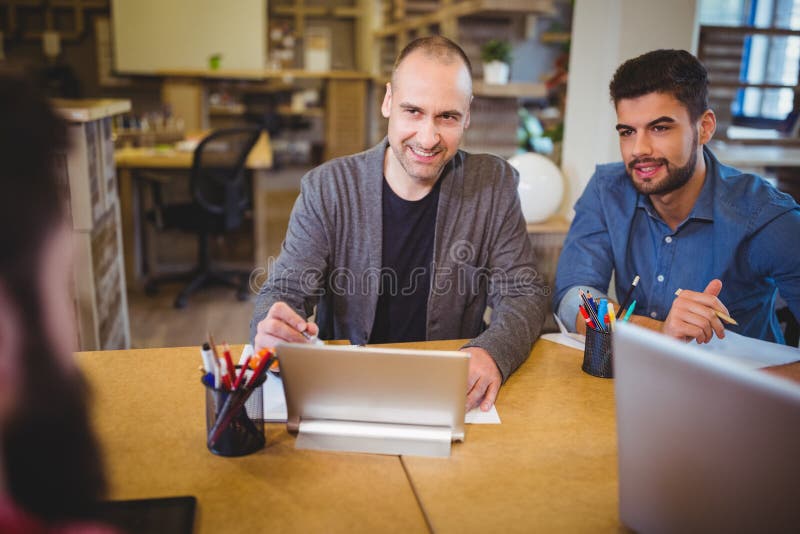 Business People Smiling while Talking at Desk Stock Image - Image of ...