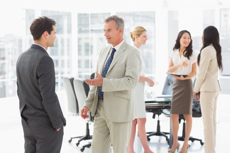 Business People Speaking Together in Conference Room Stock Image ...