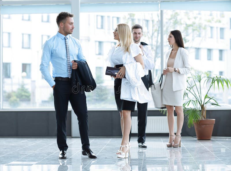 Business People Standing in the Lobby of the Modern Office. Stock Photo ...