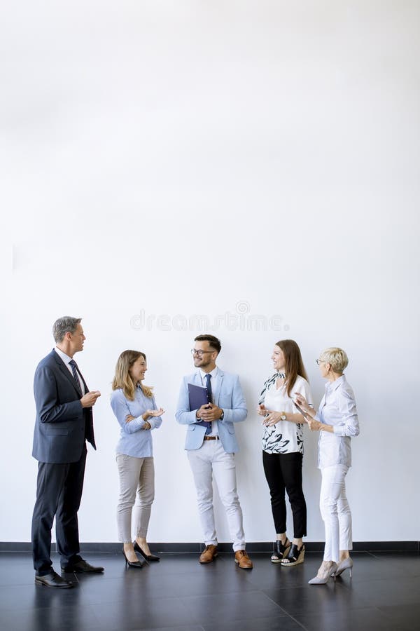 Business People Standing by the Wall in the Office Stock Image - Image ...