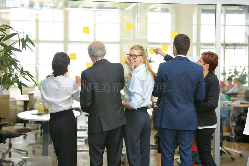 Business People Stick Notes on Wall in Office Stock Photo - Image of ...