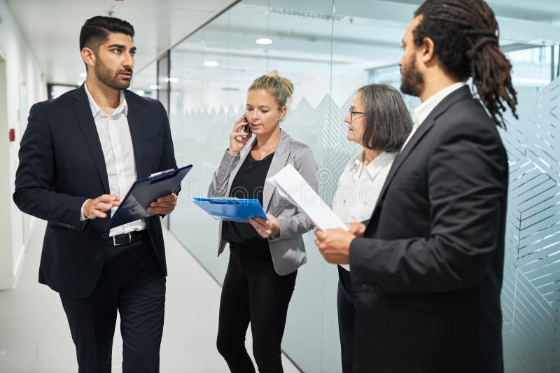 Business People Talk To Each Other on the Corridor in the Office Stock ...