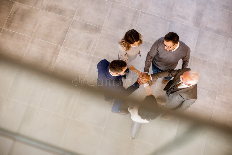 Business People Team Stack Hands As Unity Gesture in the Office Hallway ...