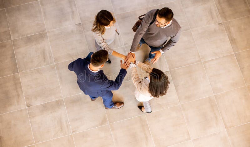 Business People Team Stack Hands As Unity Gesture in the Office Hallway ...