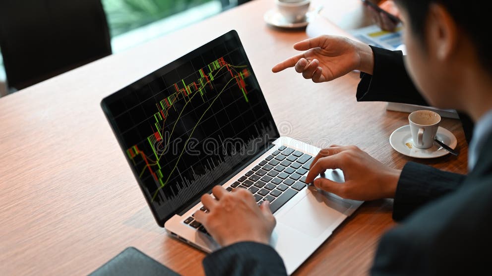 Business People are Using a Computer Laptop with a Candlestick Chart on ...