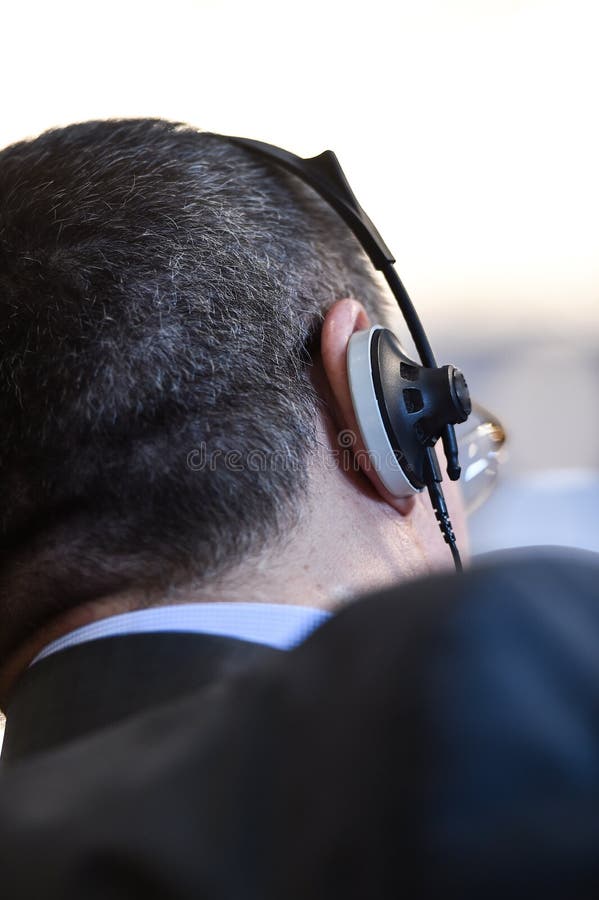 Man Using Translation Headphones Stock Photo - Image of head, event ...