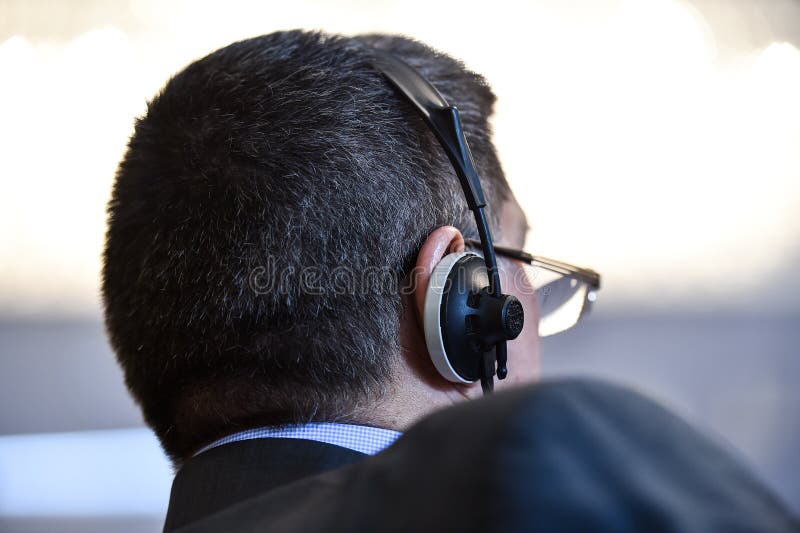 Man Using Translation Headphones Stock Photo - Image of head, event ...