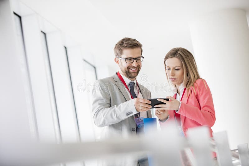 Business People Using Smart Phone in Convention Center Stock Photo ...