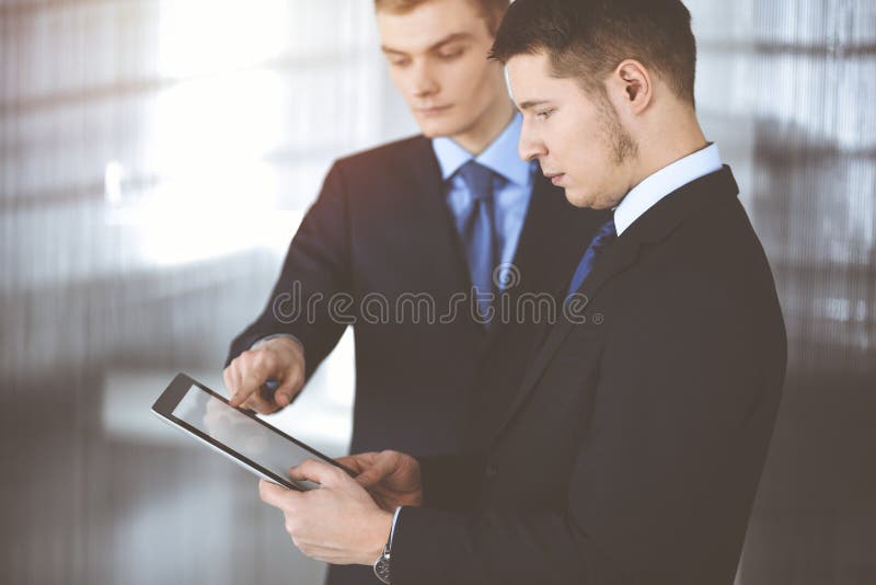 Business People, Using a Tablet Computer, while Standing in Sunny ...