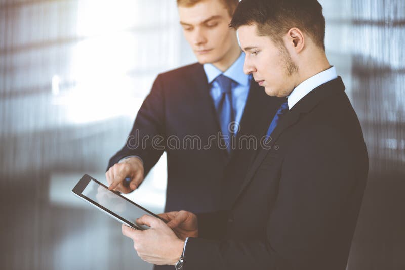 Business People, Using a Tablet Computer, while Standing in Sunny ...