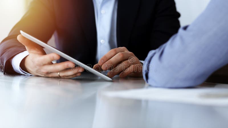 Business People Using Tablet Computer while Working Together in Sunny ...