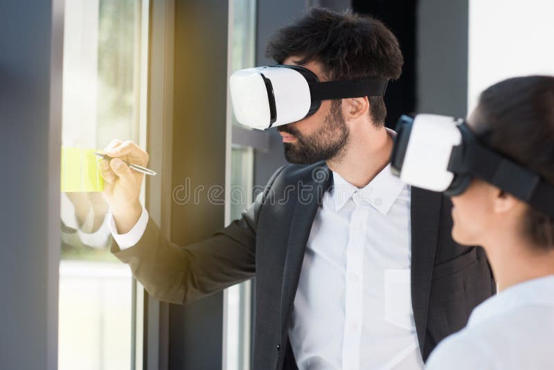 Business People Wearing Virtual Reality Headsets while Working in ...