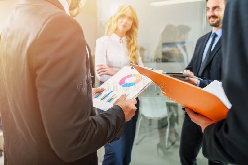 Business People Work Together in Office with Stats and Reports Stock ...