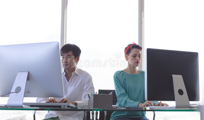 Business People Working on Computer at Desk in Office Stock Photo ...