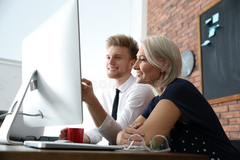 Business People Working on Computer at Table in Office Stock Photo ...